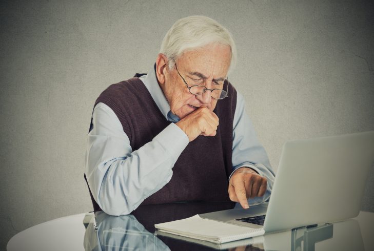 Elderly old man using laptop computer sitting at table – SOLUTIONS FOR ...